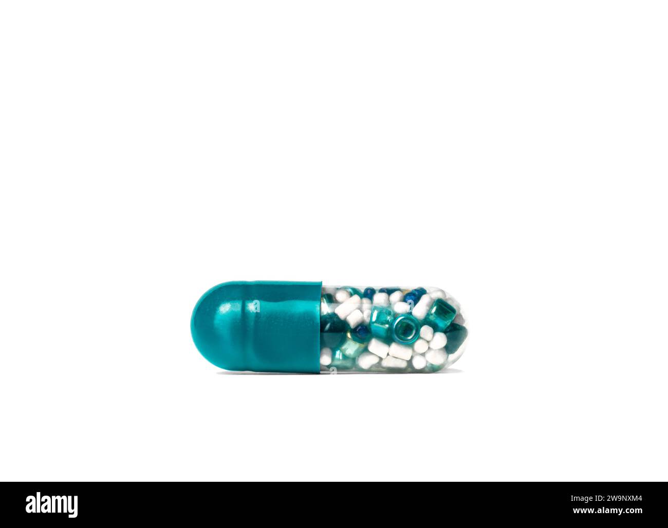 Blue medicine capsule with colored small granules and beads inside ...
