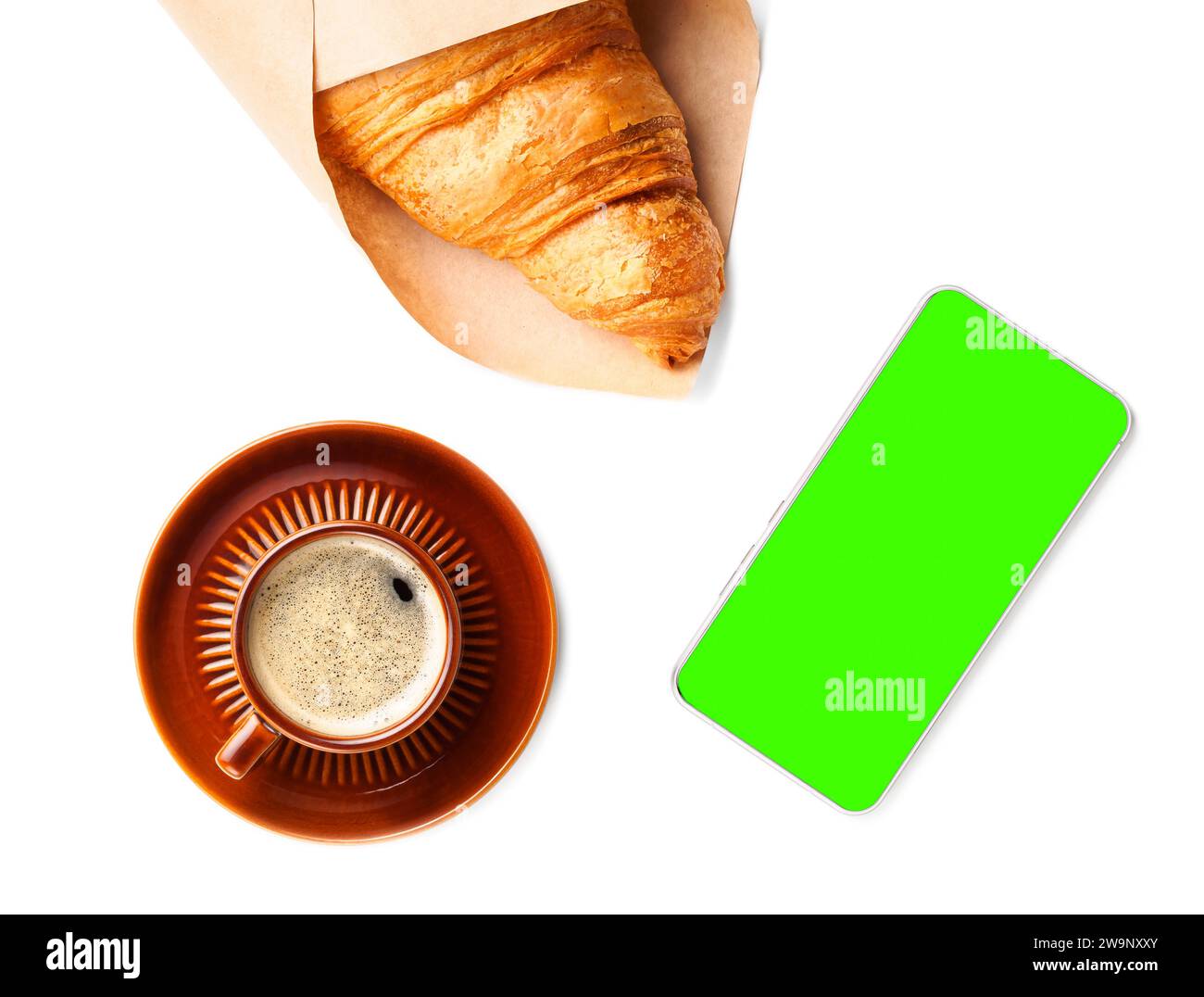Flat lay of brown cup of black coffee with croissant and phone ...