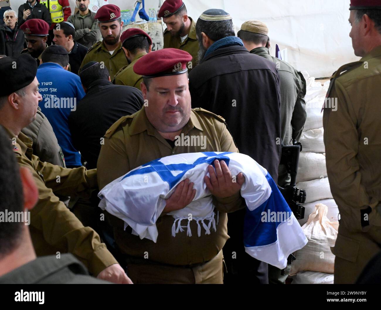 Jerusalem, Israel. 29th Dec, 2023. A soldier carries the flag off the ...