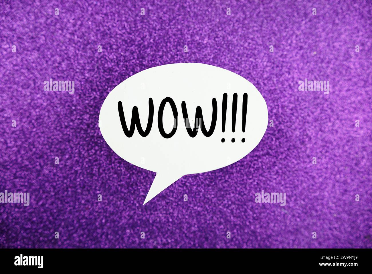 WOW!!! text message in white bubble speech top view on purple ...