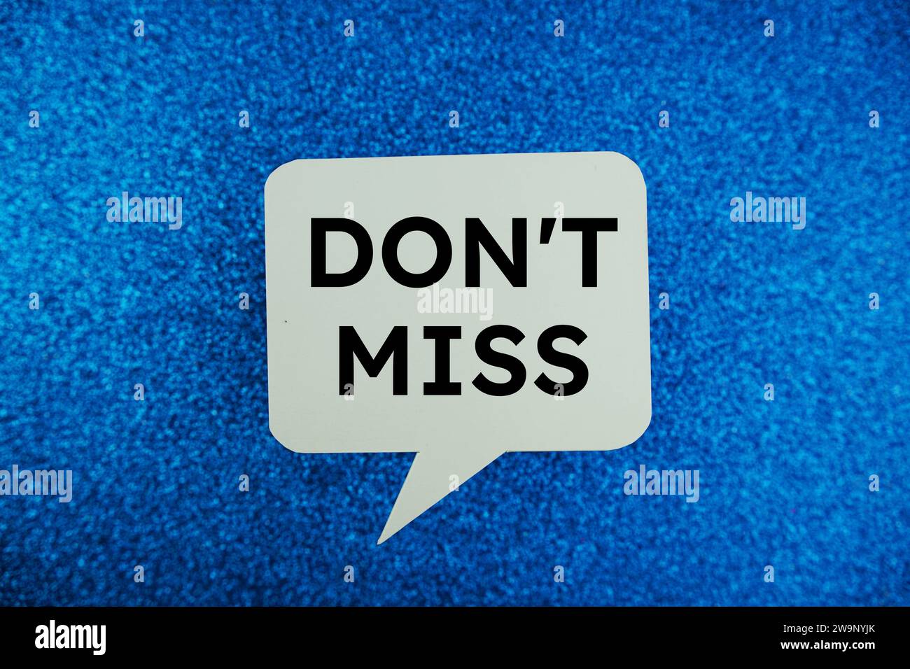 Don't Miss text message in white bubble speech top view on blue ...
