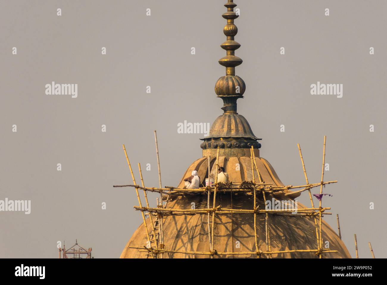 Workers on scaffolds restauring the outside dome of Mushir Zadi tomb ...