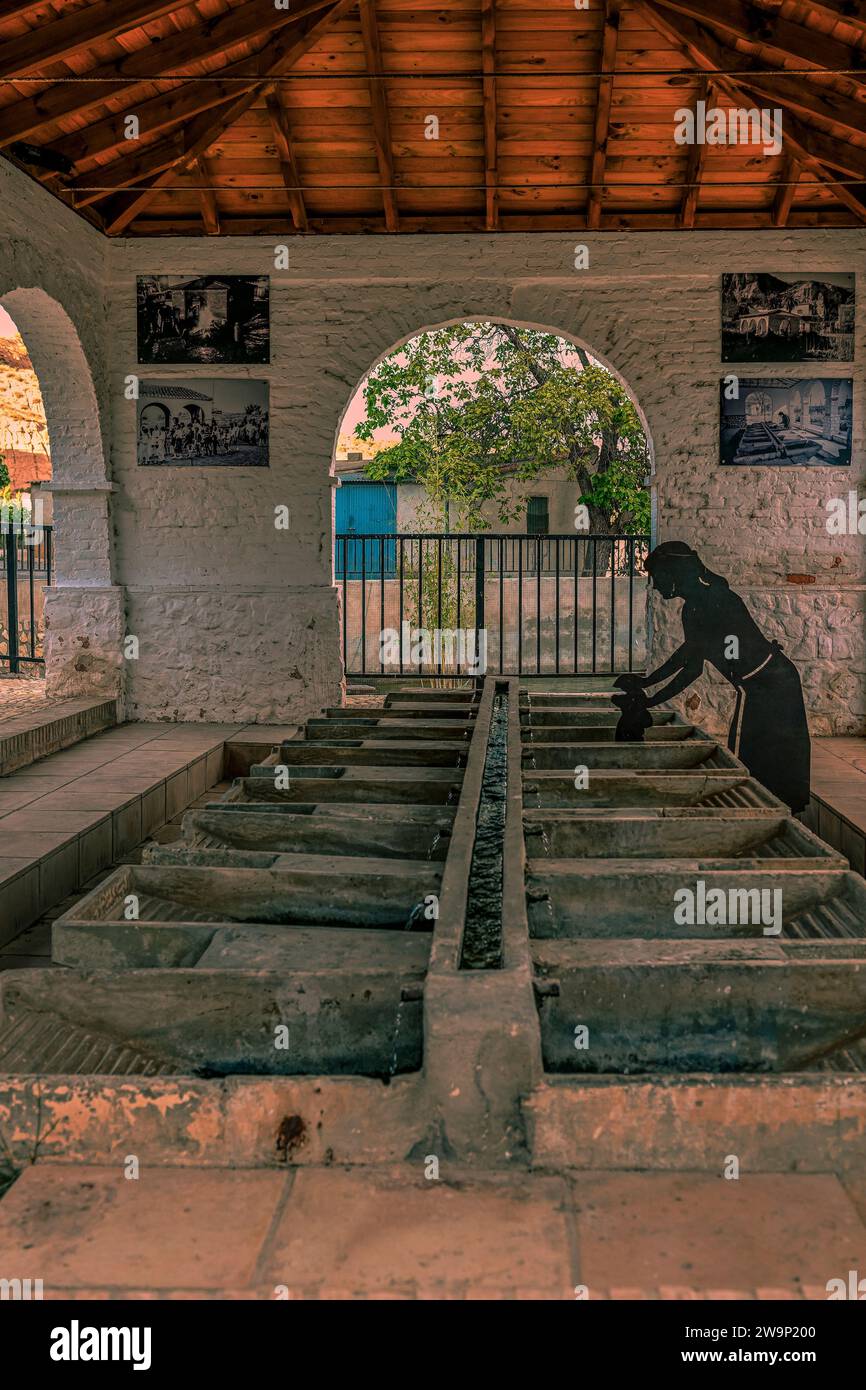 Traditional stone washbasins at an old public laundry house, with ...