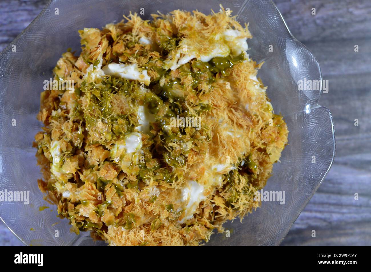 Pistachio sauce on top of Sweet Koshary recipe in Egypt made of multi ...