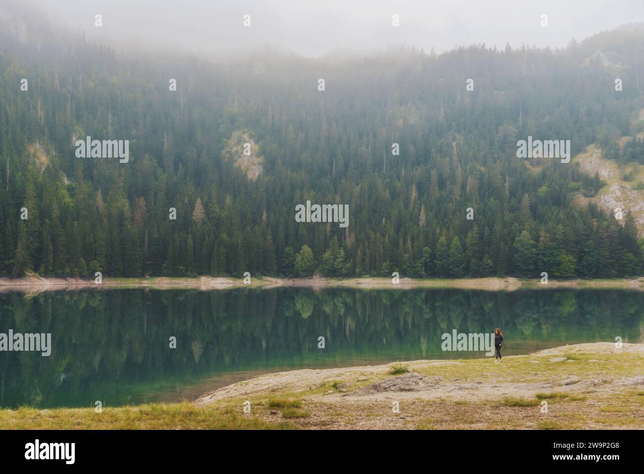 Woman Walking on Lakeside of Mountain Lake in Durmitor Stock Photo - Alamy