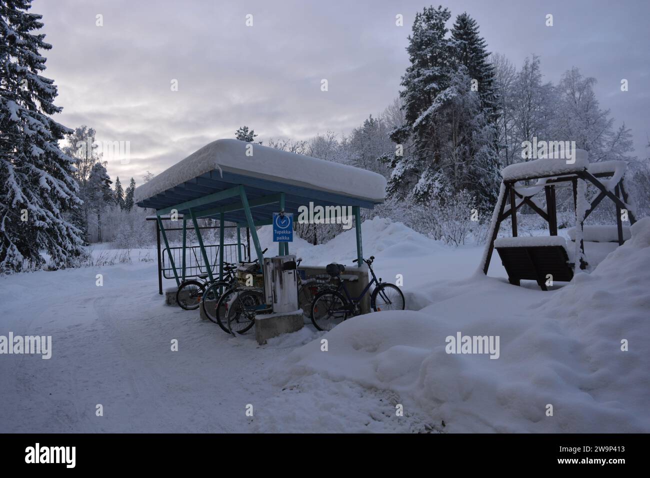 Bicycle parking, bicycles under a canopy with lots of snow in the city ...