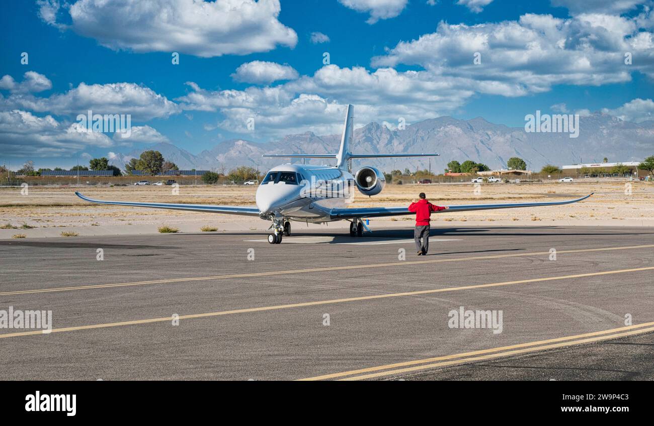 Private jet being marshaled into an aloted parking space at Tucson ...