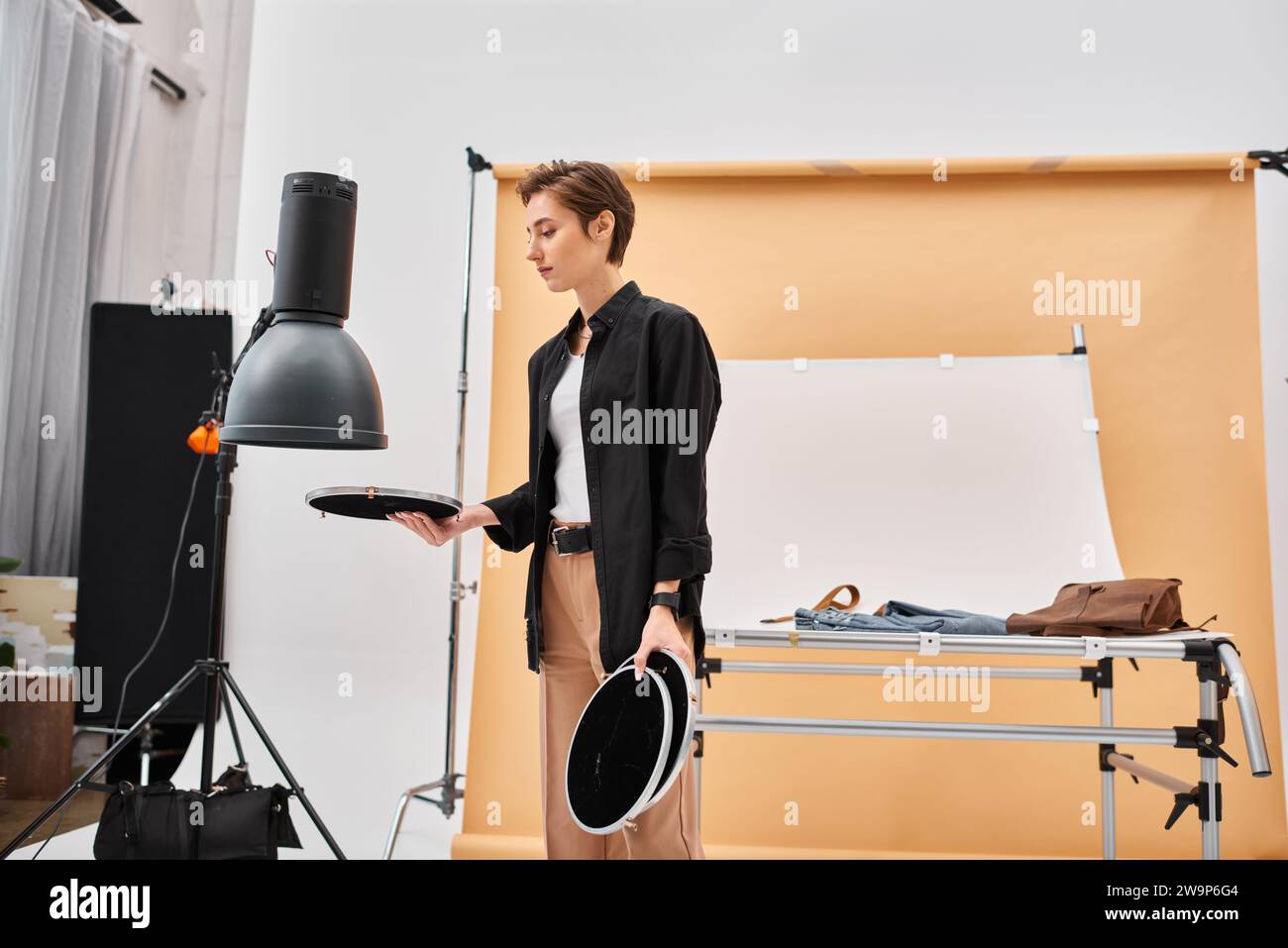 good looking short haired female photographer in casual attire working ...