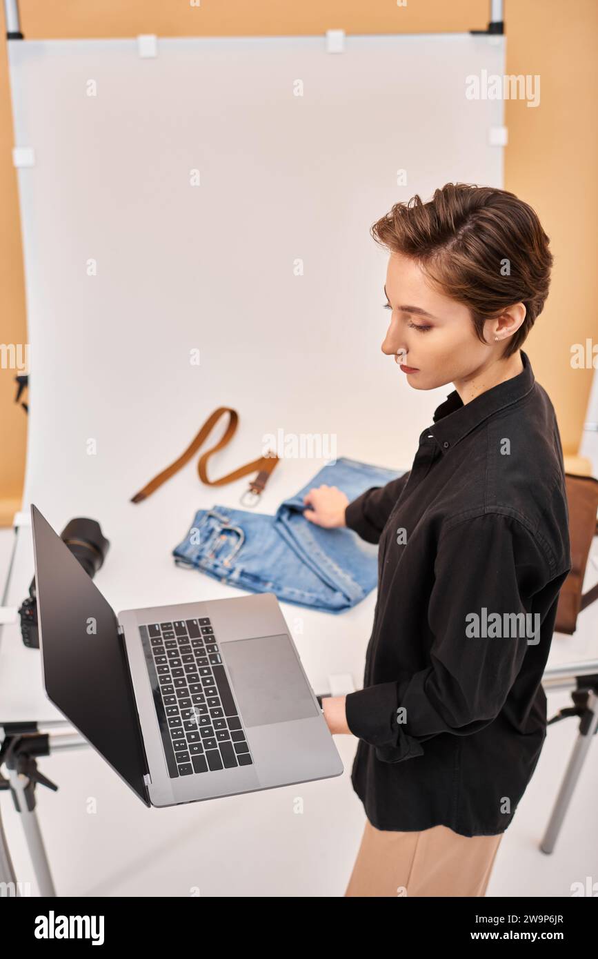 attractive female photographer preparing for fashion photoshoot using ...