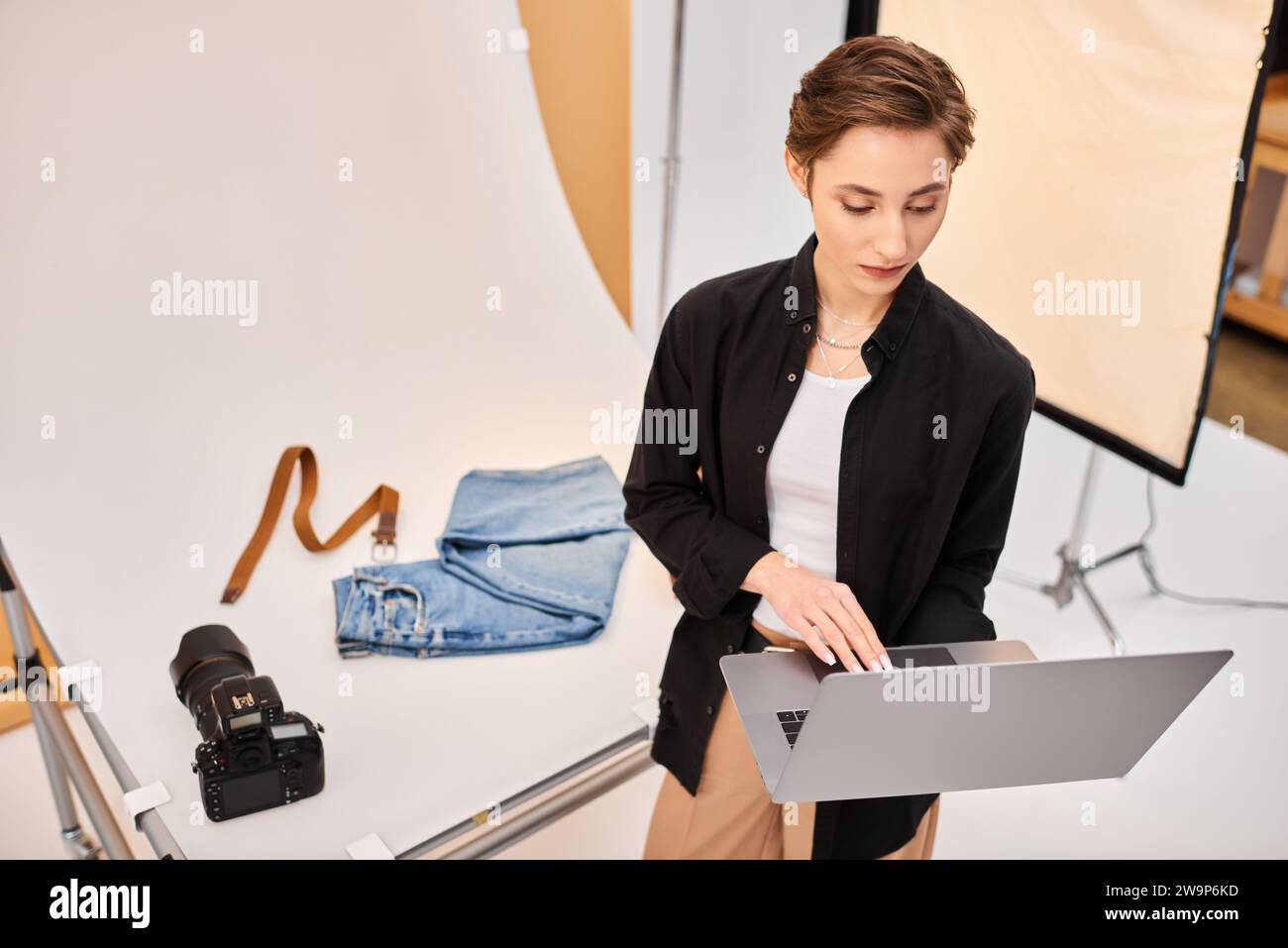 good looking female photographer preparing for fashion photoshoot using ...