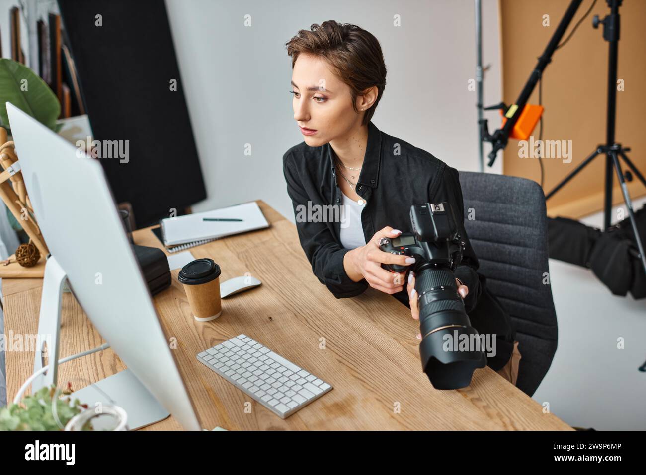 pretty professional female photographer in casual wear retouching ...