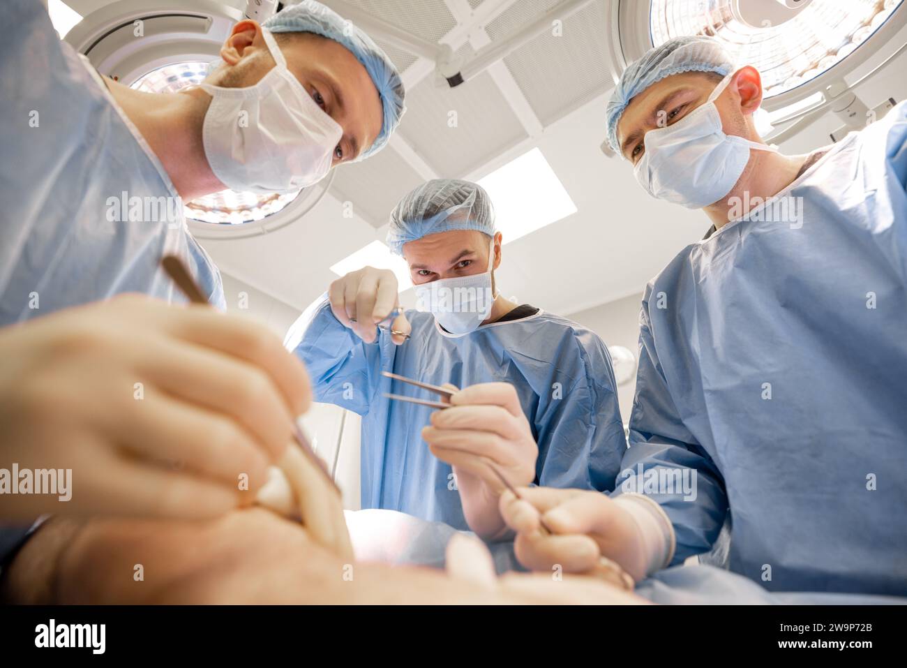 Scary surgeons look at the place of surgical interventio Stock Photo ...