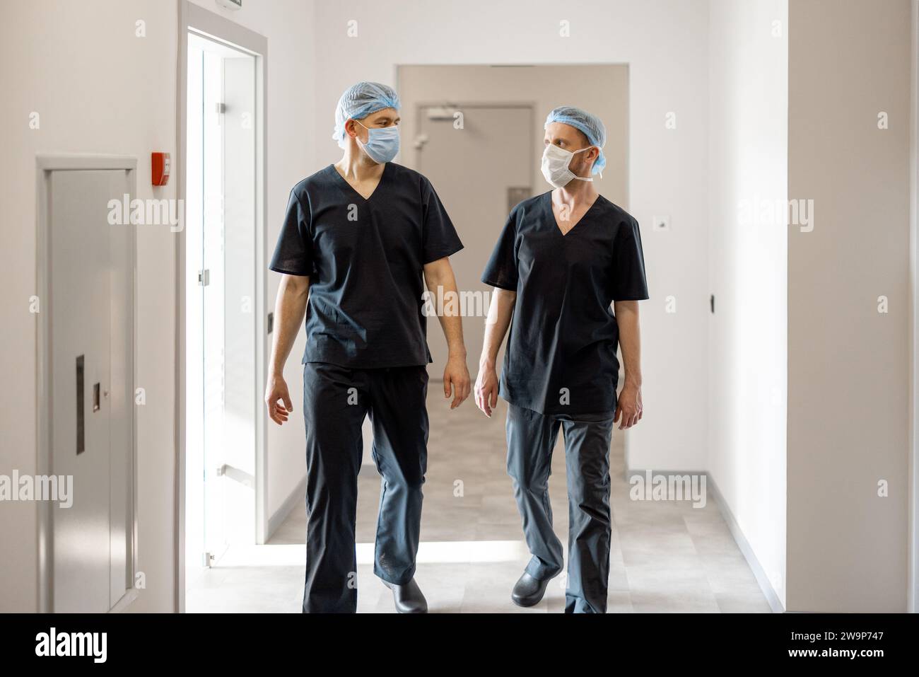 Surgeons walk at the hallway of clinic Stock Photo - Alamy