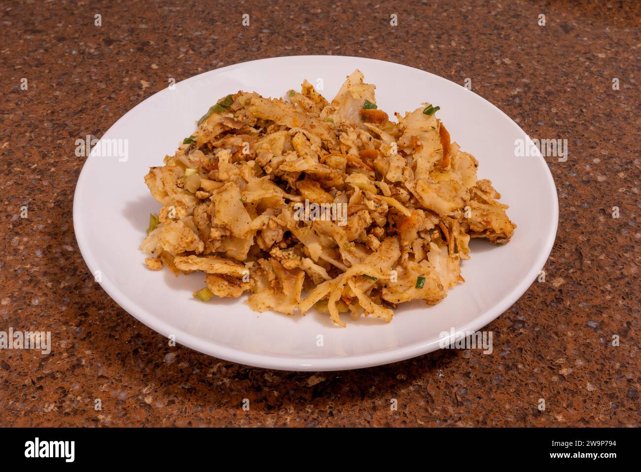 Sri Lankan kottu roti on a white plate against a black background Stock ...