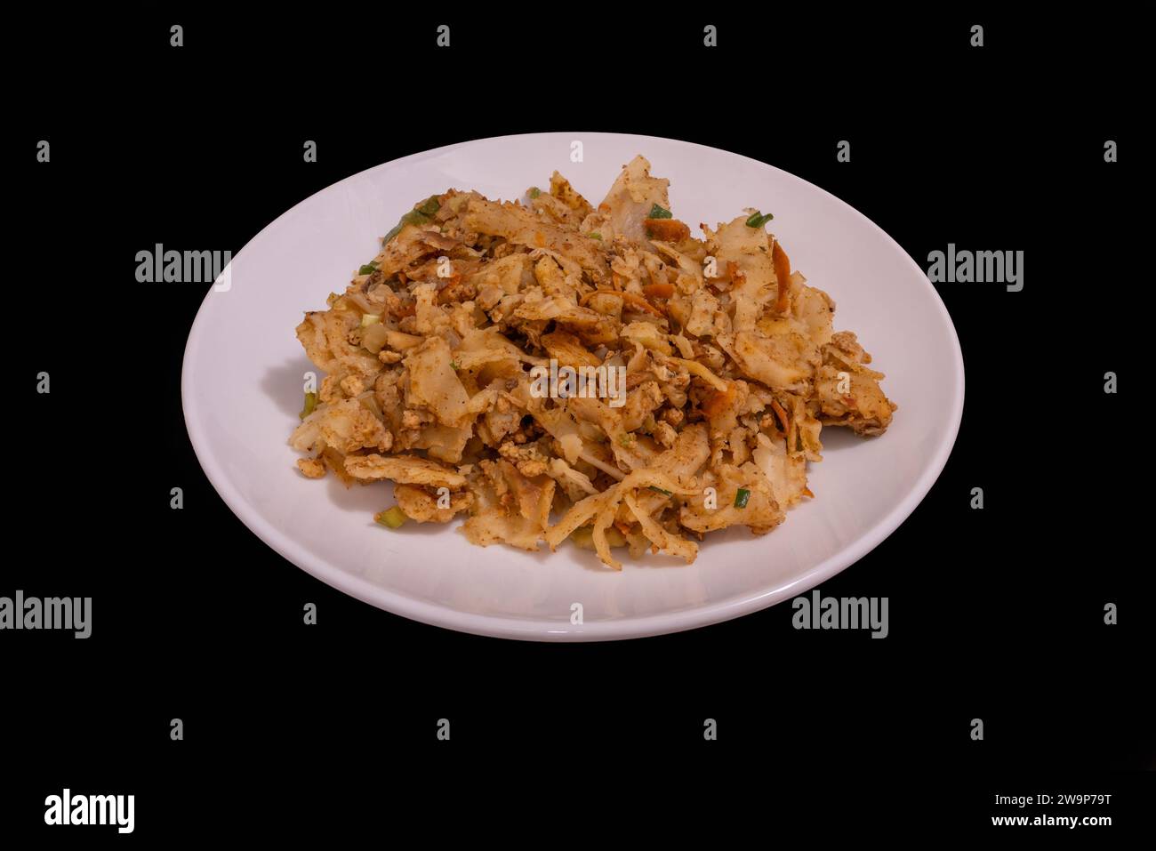 Sri Lankan kottu roti on a white plate against a black background Stock ...