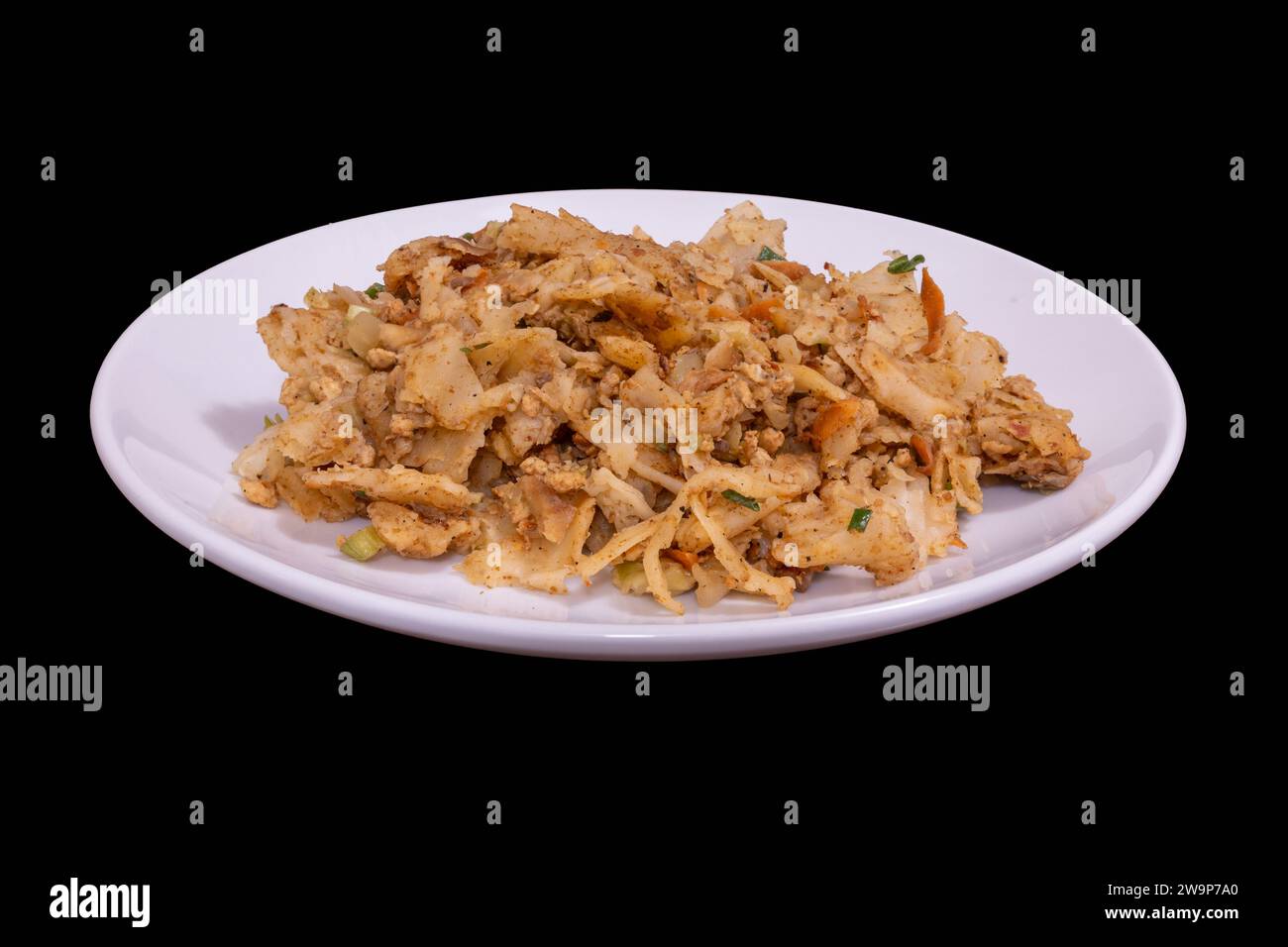Sri Lankan Kottu Roti on a white plate against a black background Stock ...