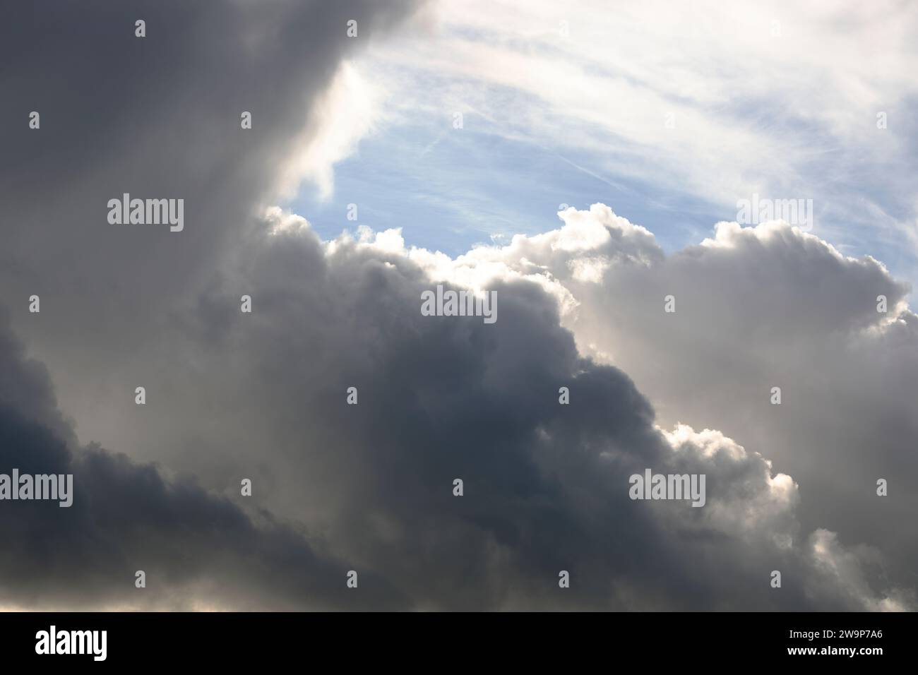A cloudy sky after a storm with blue sky coming through Stock Photo - Alamy