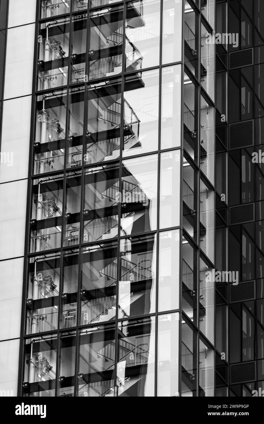 Glassed-in stairwell on the exterior of a tall building in the downtown ...