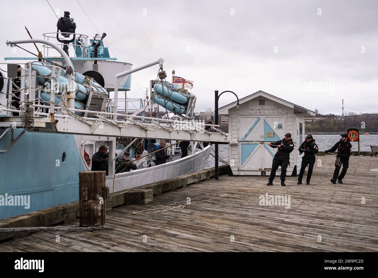 Sailors of the Royal Canadian Navy assist in bringing the preserved ...