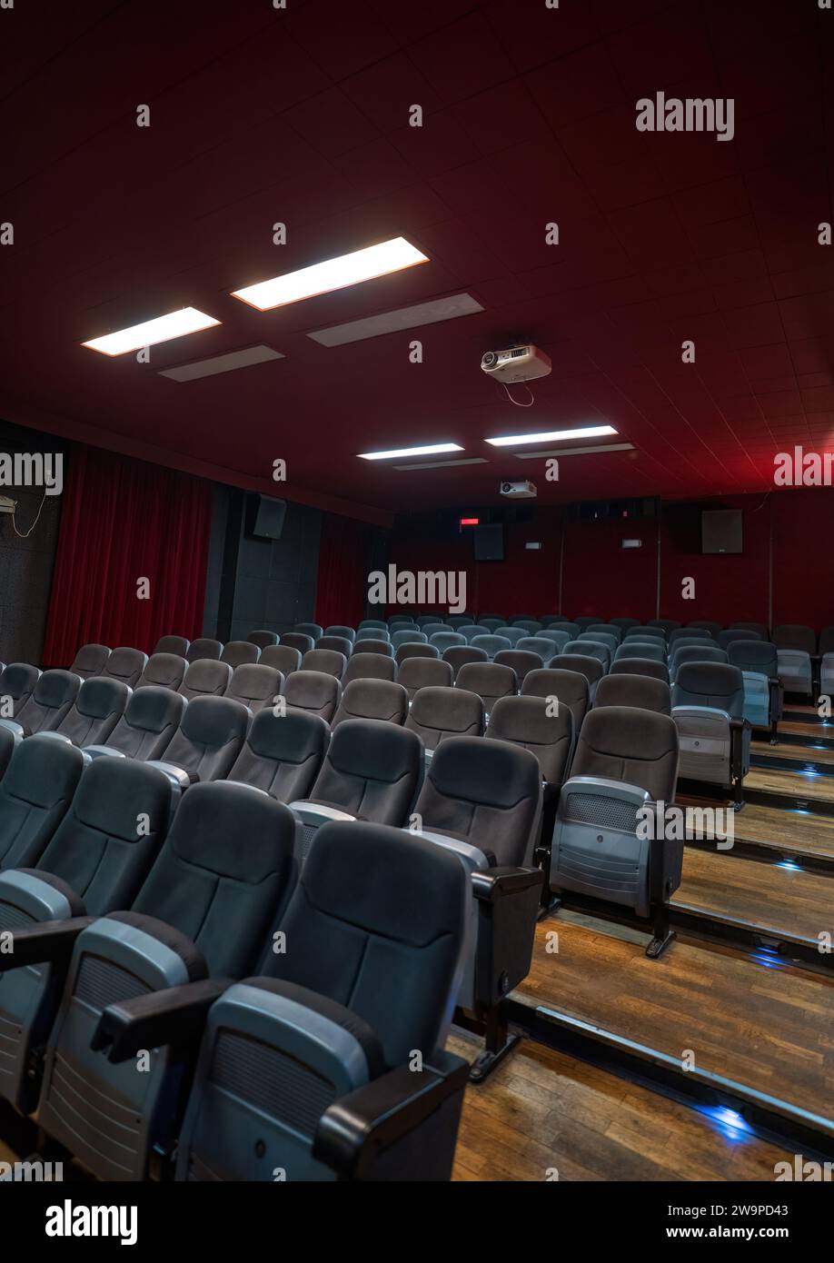 Interior of a cinema hall with projector handing on the ceiling, Empty ...