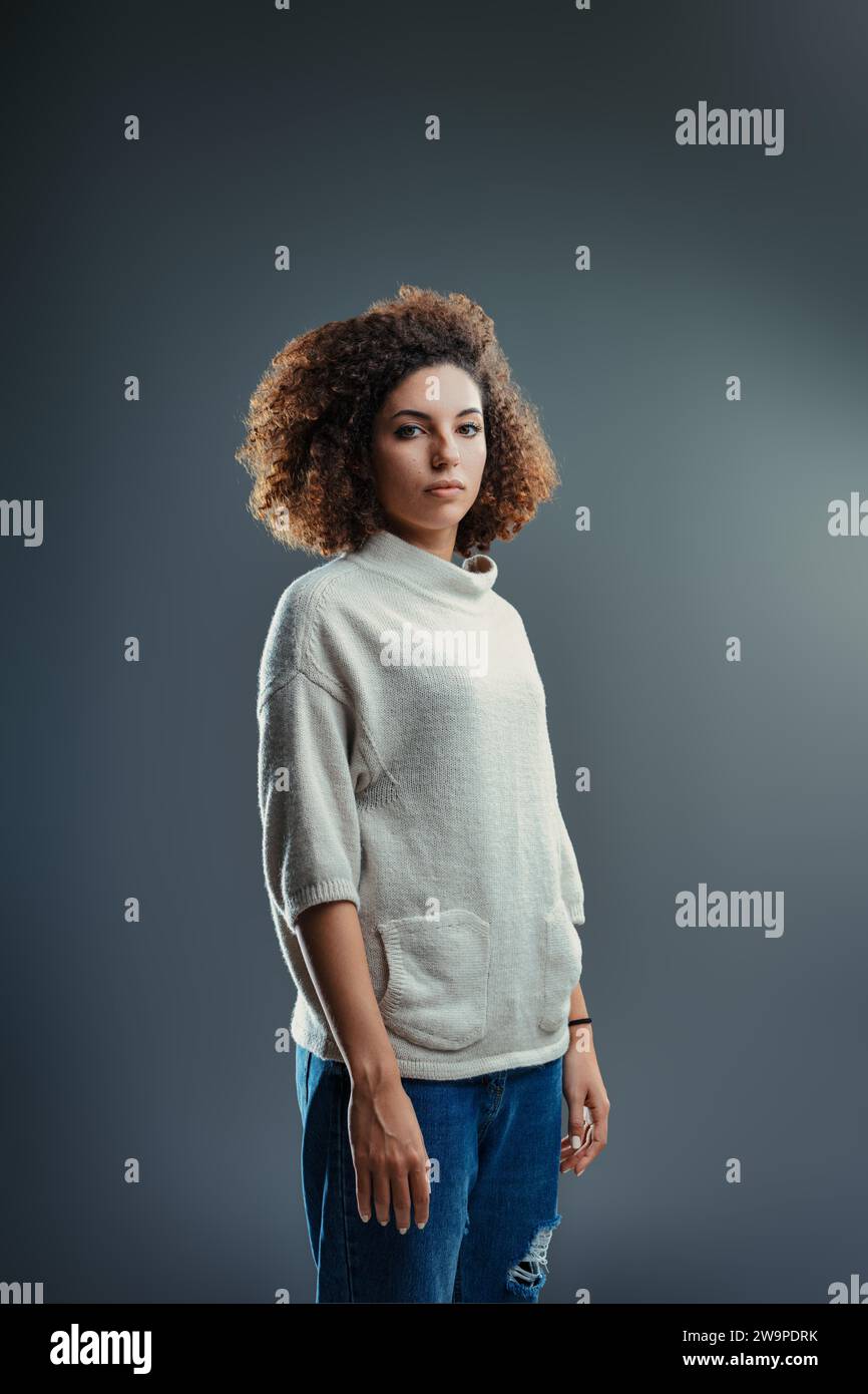 Reflective and calm, the woman's soft stare and curly hair tell a story ...