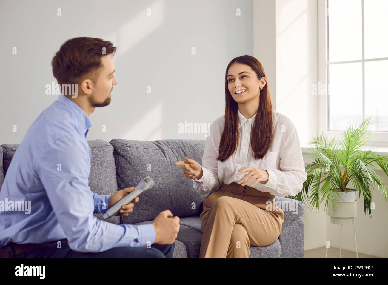 Successful famous young actress giving interview to male host on ...