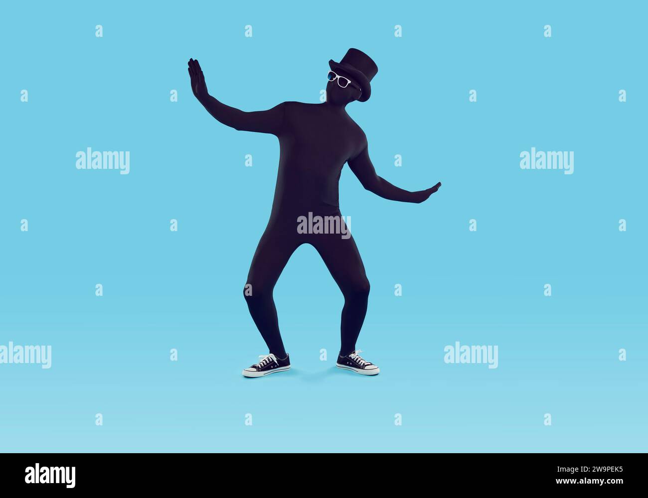 Funny man disguised in a black bodysuit, sunglasses and hat dancing on ...