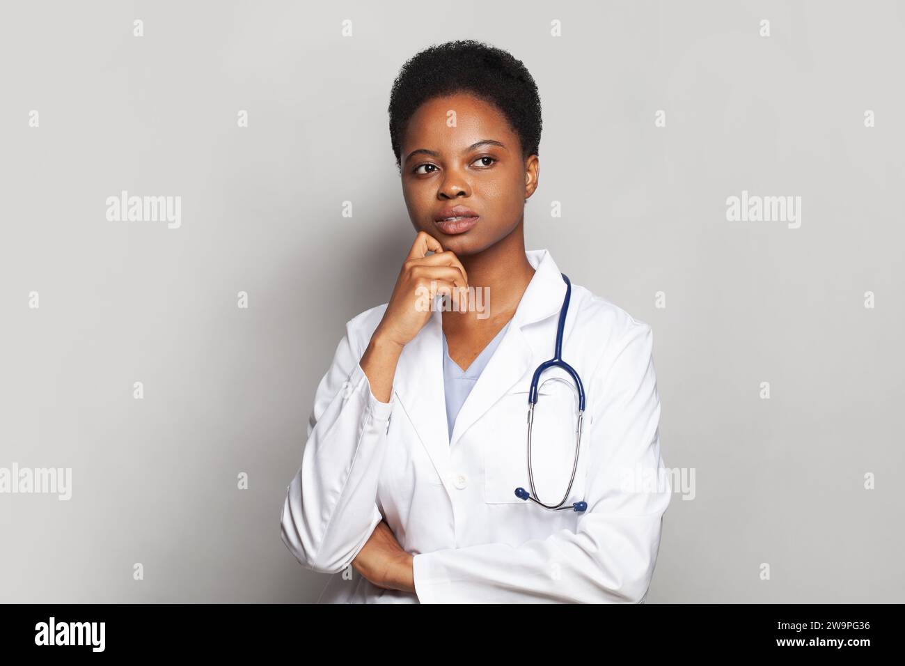 Smart thinking physician woman medical worker with stethoscope standing ...