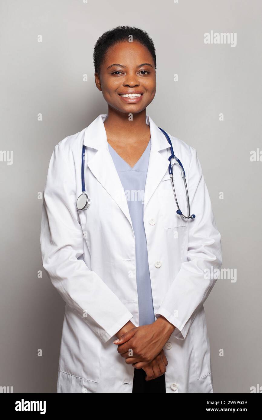 Good-looking happy doctor woman medical worker in lab coat on white ...