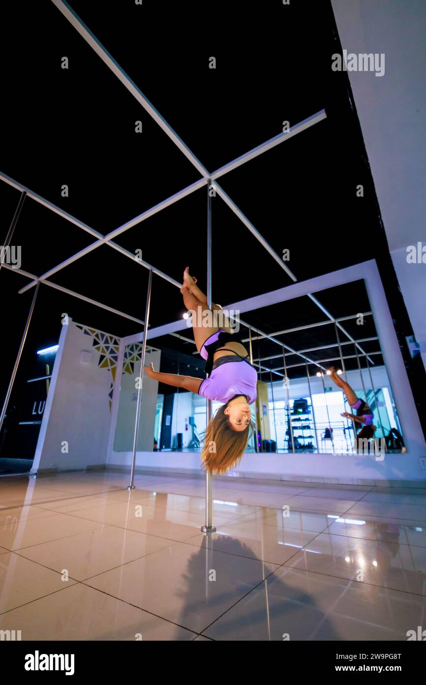 A Confident And Empowered Latina Woman Engages In Pole Dancing In An