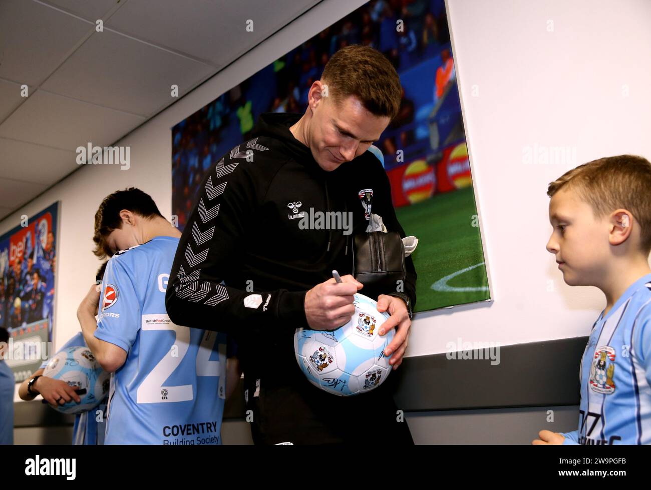 Coventry City Goalkeeper Ben Wilson Signs A Ball For A Matchday Mascot