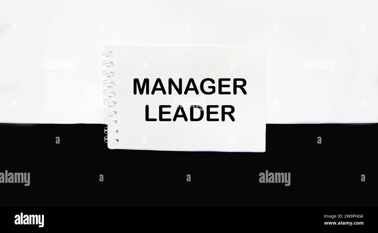Manager and leader, written on a notepad. Beautiful white and black ...