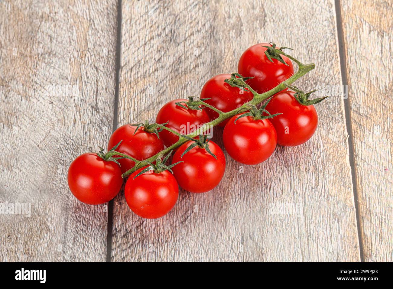 Ripe sweet cherry tomato branch isolated Stock Photo - Alamy