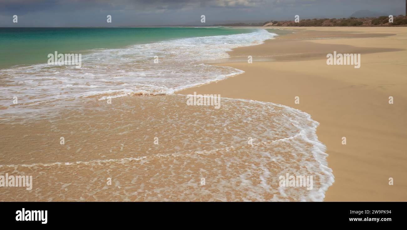 Daytime landscape of the beautiful Praia de Abrabas with long sea waves ...