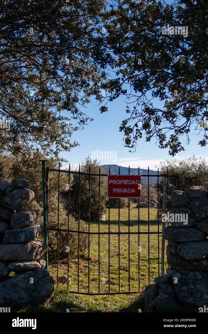 Translation: Private property. Iron bar gate on a dry stone fence that ...