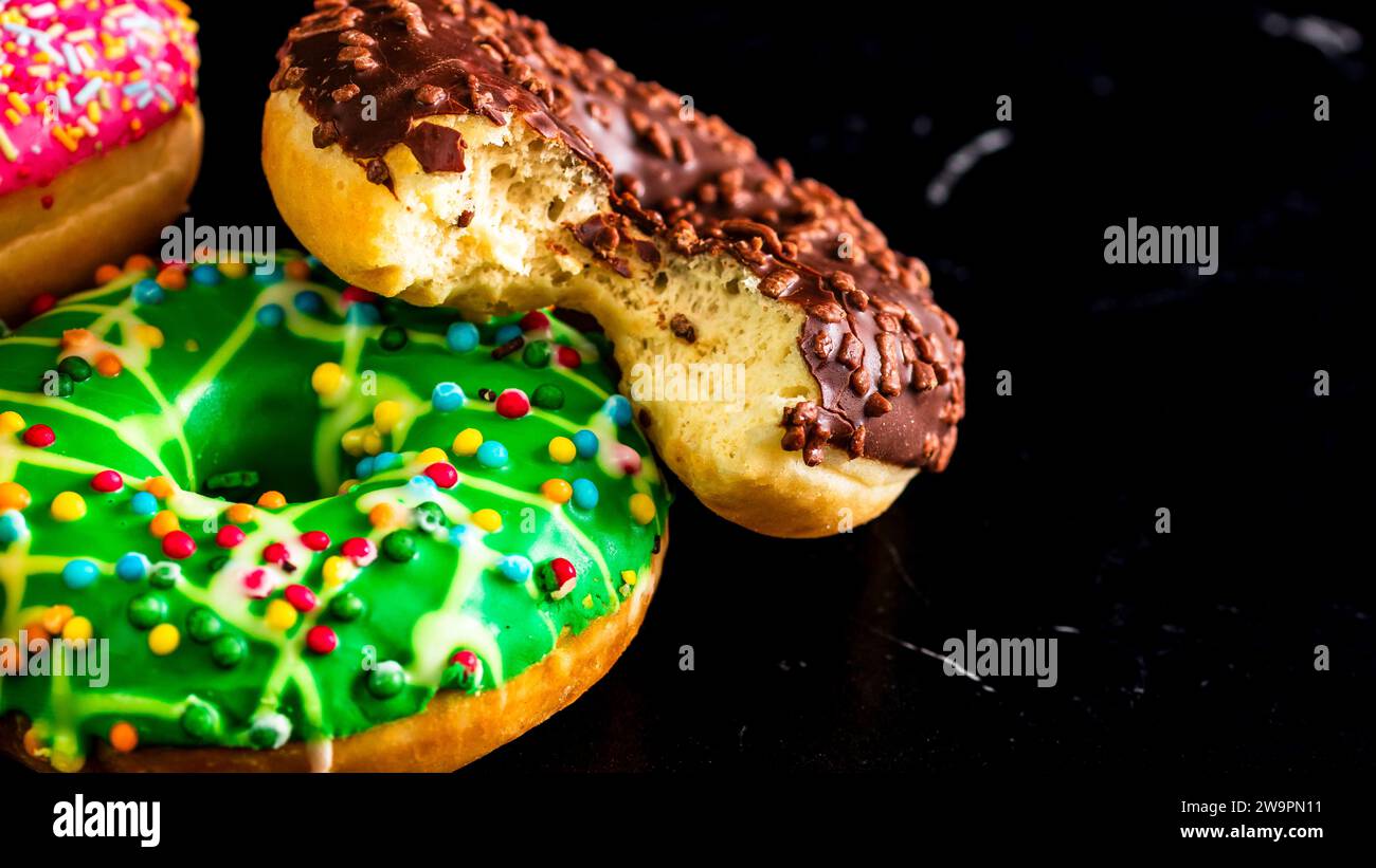 Glazed donuts with sprinkles isolated. Close up of colorful donuts ...