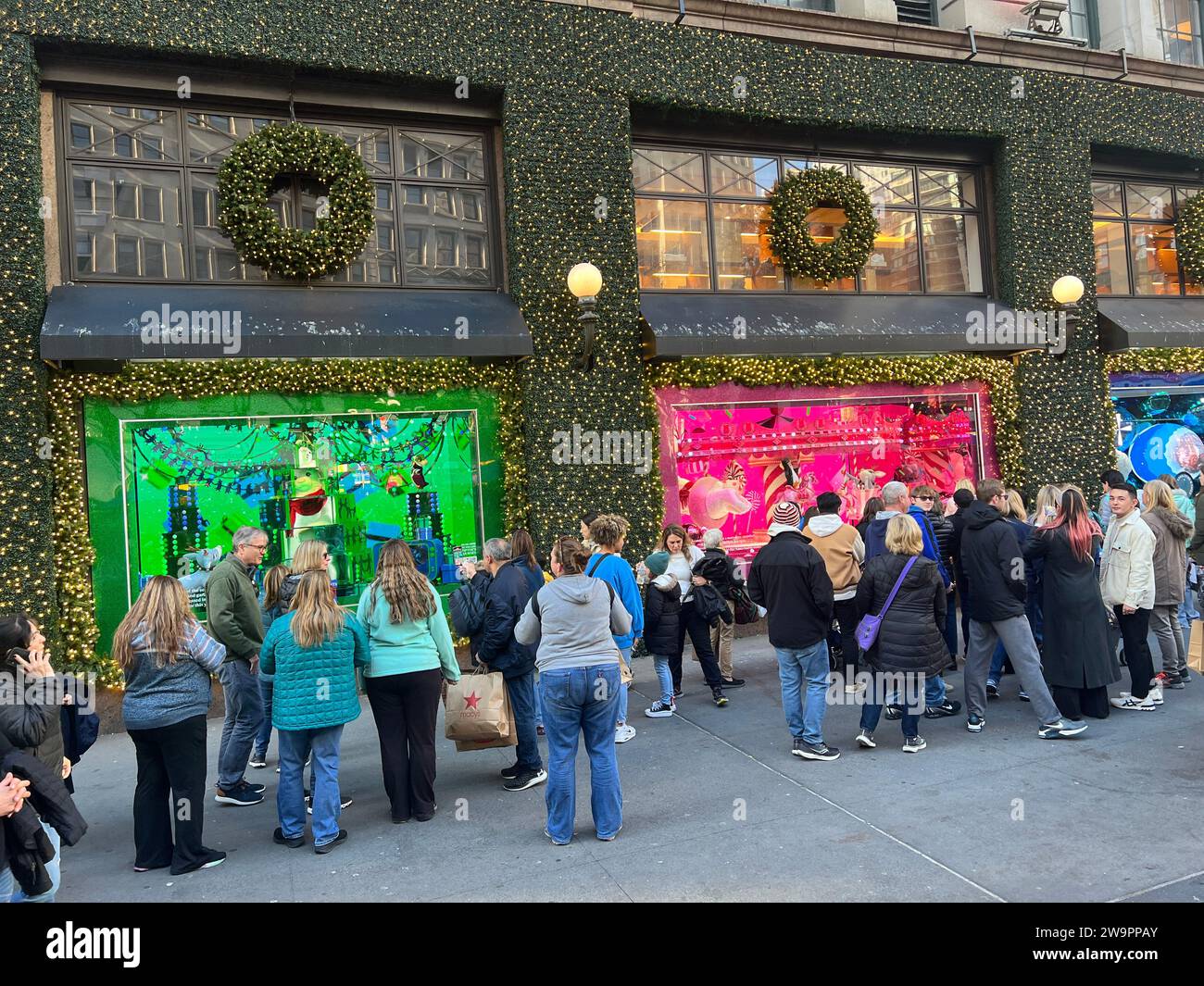 People enjoy the Cristmas holiday windows along the Broadway side of ...