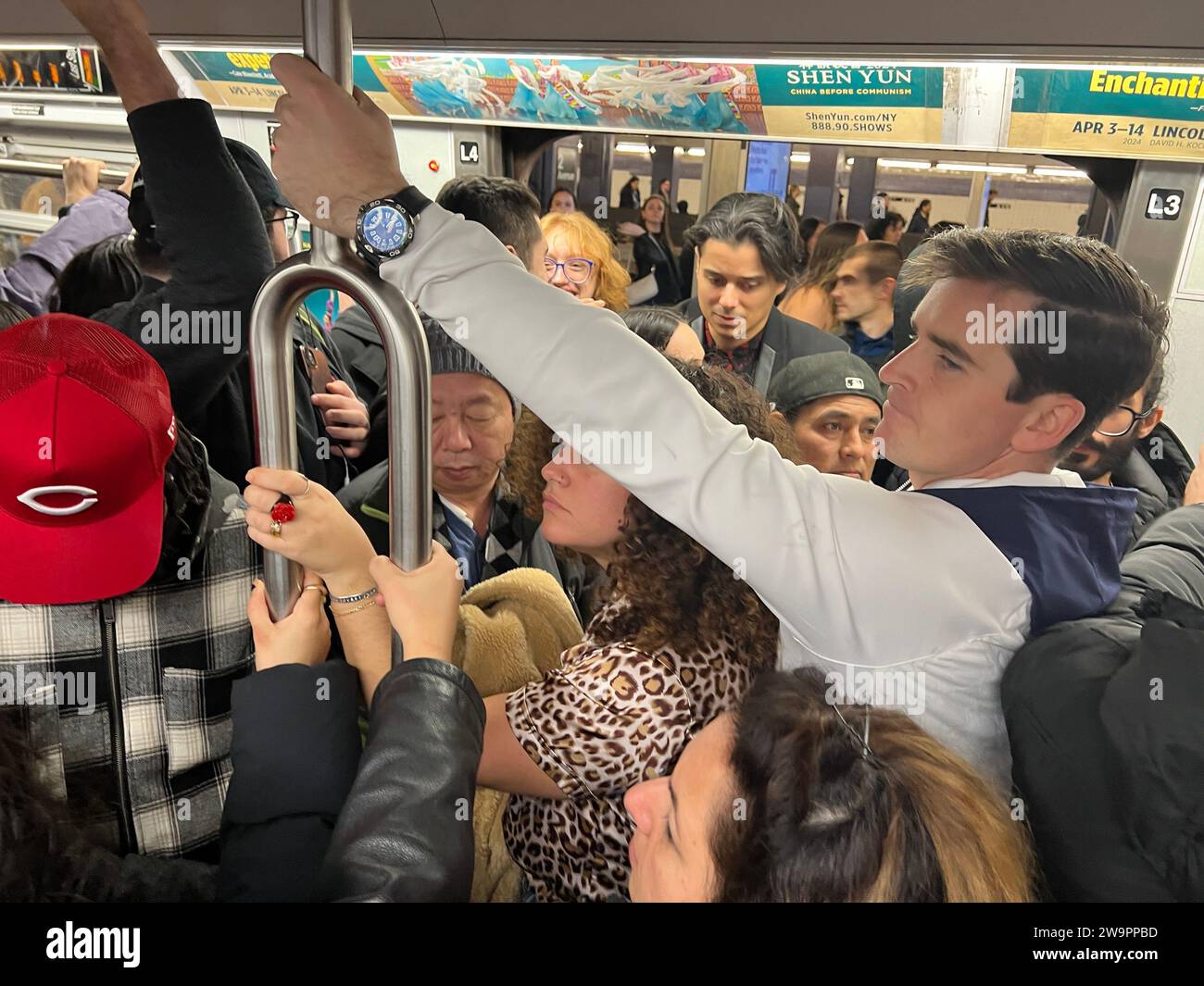 Riders crowd into an already crowded subway train in midtown Manhattan ...