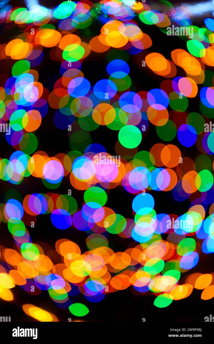 Large vibrant green, red, orange and blue bokeh balls swirling and ...