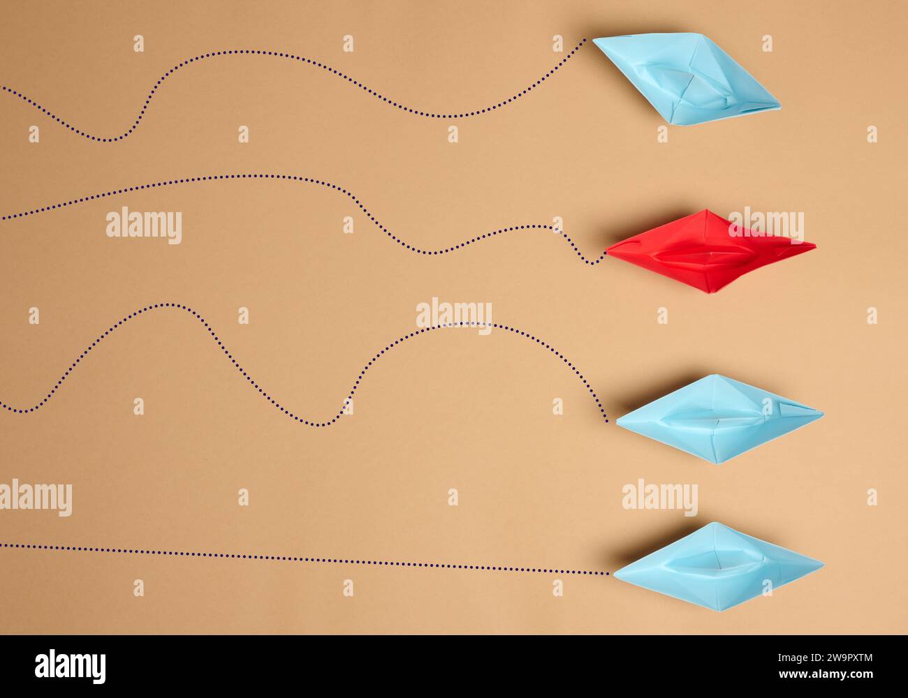 Paper boats on a brown background with paths of movement, representing ...