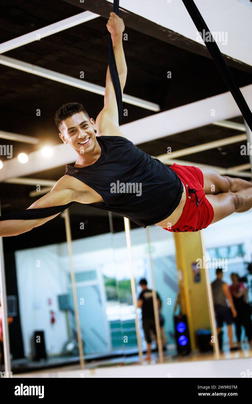 As the acrobat glides through the air, the silk fabric becomes an ...