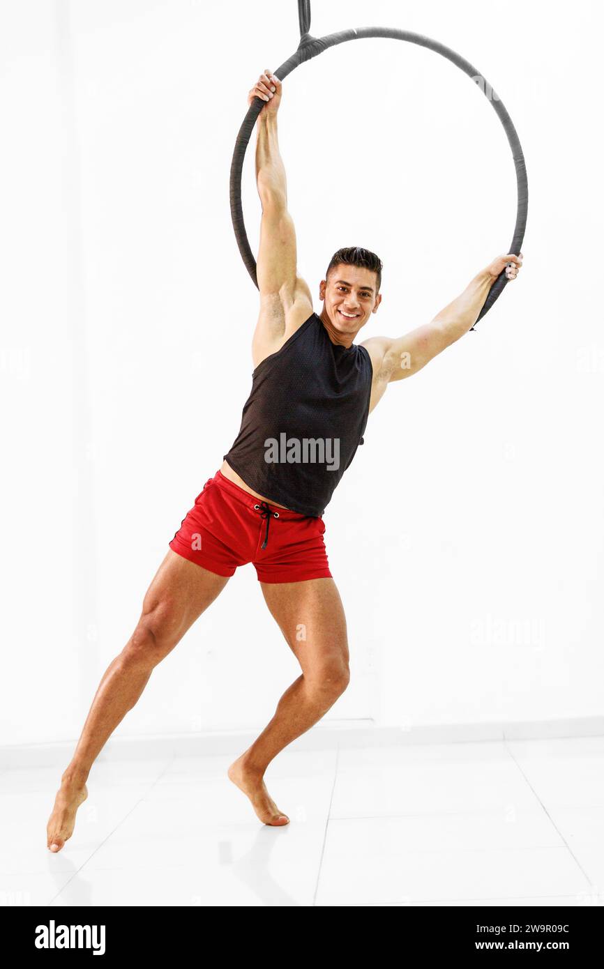 A solo aerial ring performance by a Mexican gymnast showcases muscular ...