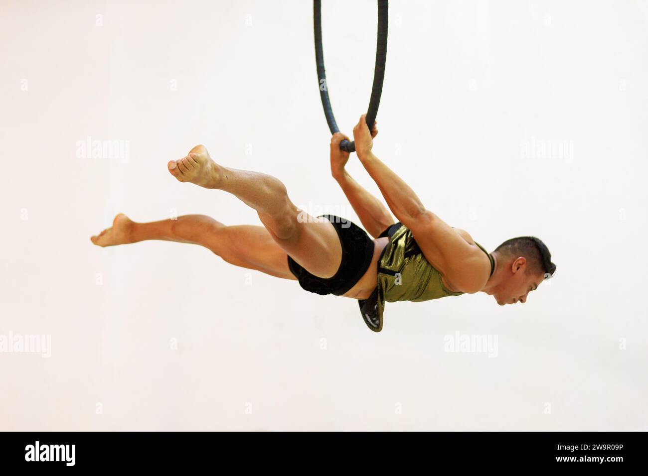 A Mexican male gymnast crafts a solo aerial routine, demonstrating a ...