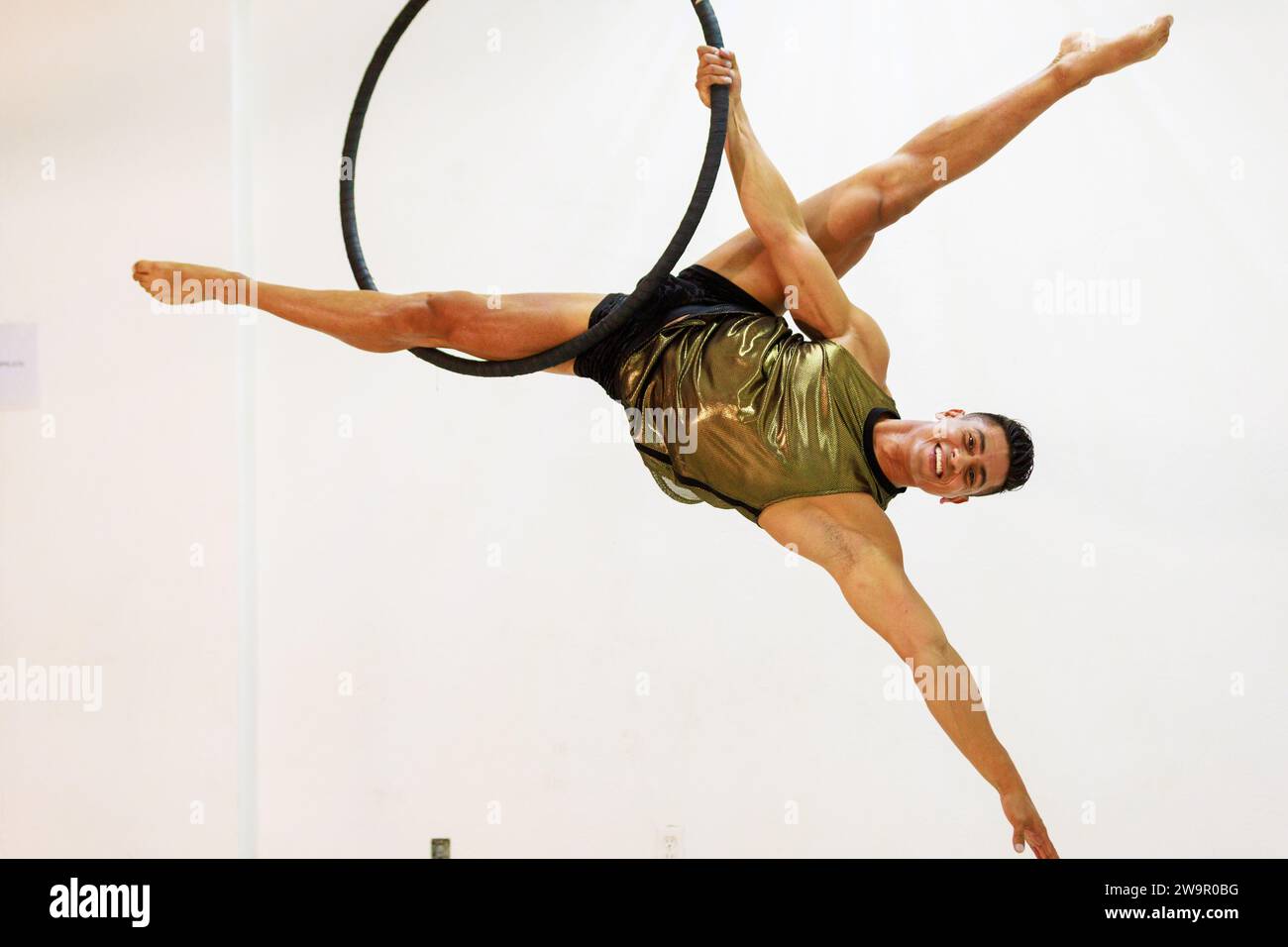 a Cirque-style performance, a Mexican gymnast on the aerial ring evokes ...
