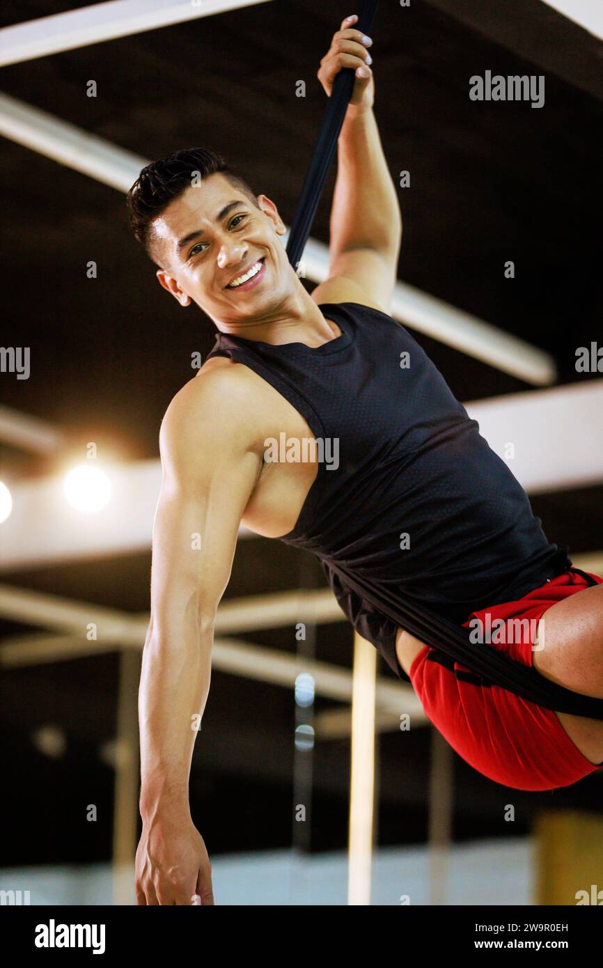 The vibrant hues of the silk fabric complement the acrobat's fluid ...