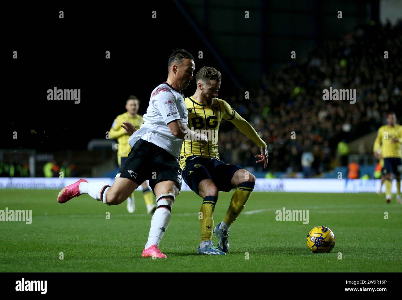 Derby County's Kane Wilson (left) and Oxford United's Joe Bennett ...