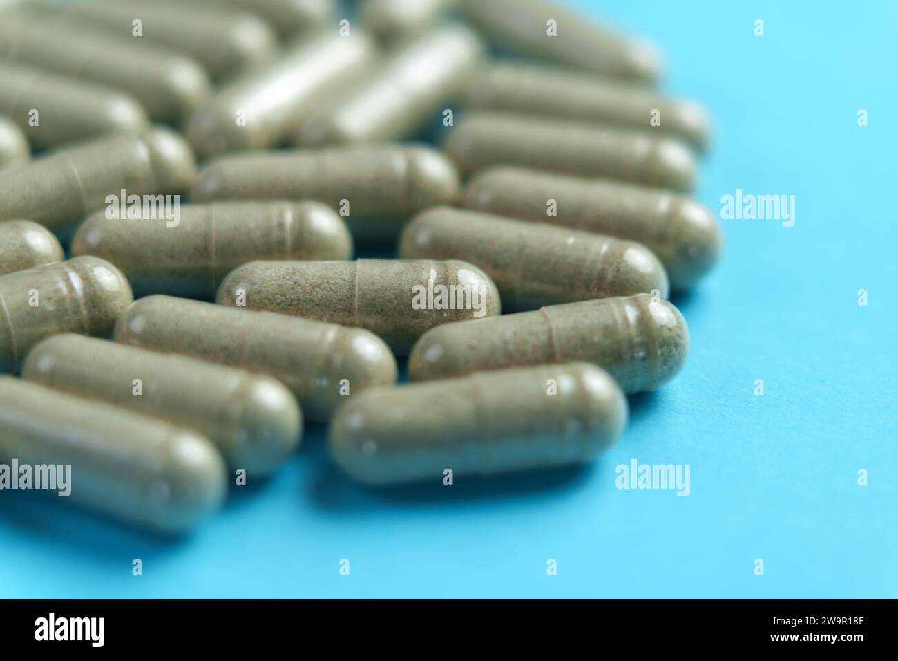 White medication pills on a blue background. Healthcare medicament ...