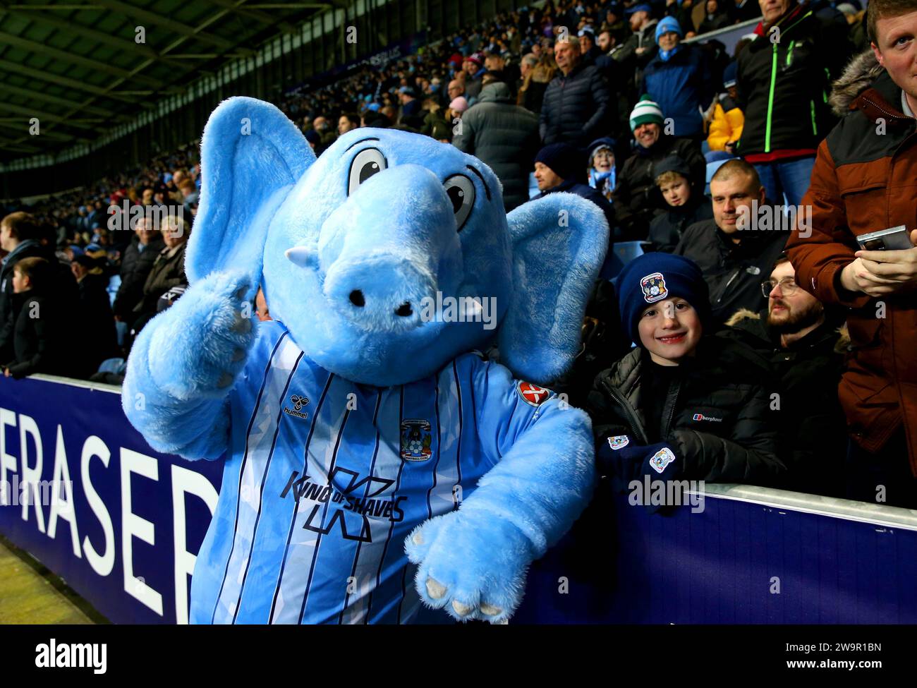 Coventry City mascot Sky Blue Sam poses for a photo with a fan in the ...