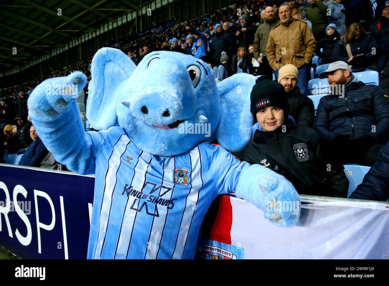 Coventry City mascot Sky Blue Sam poses for a photo with a fan in the ...