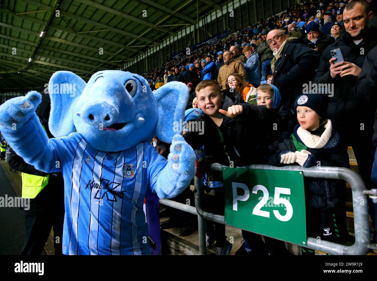 Coventry City mascot Sky Blue Sam poses for a photo with a fan in the ...